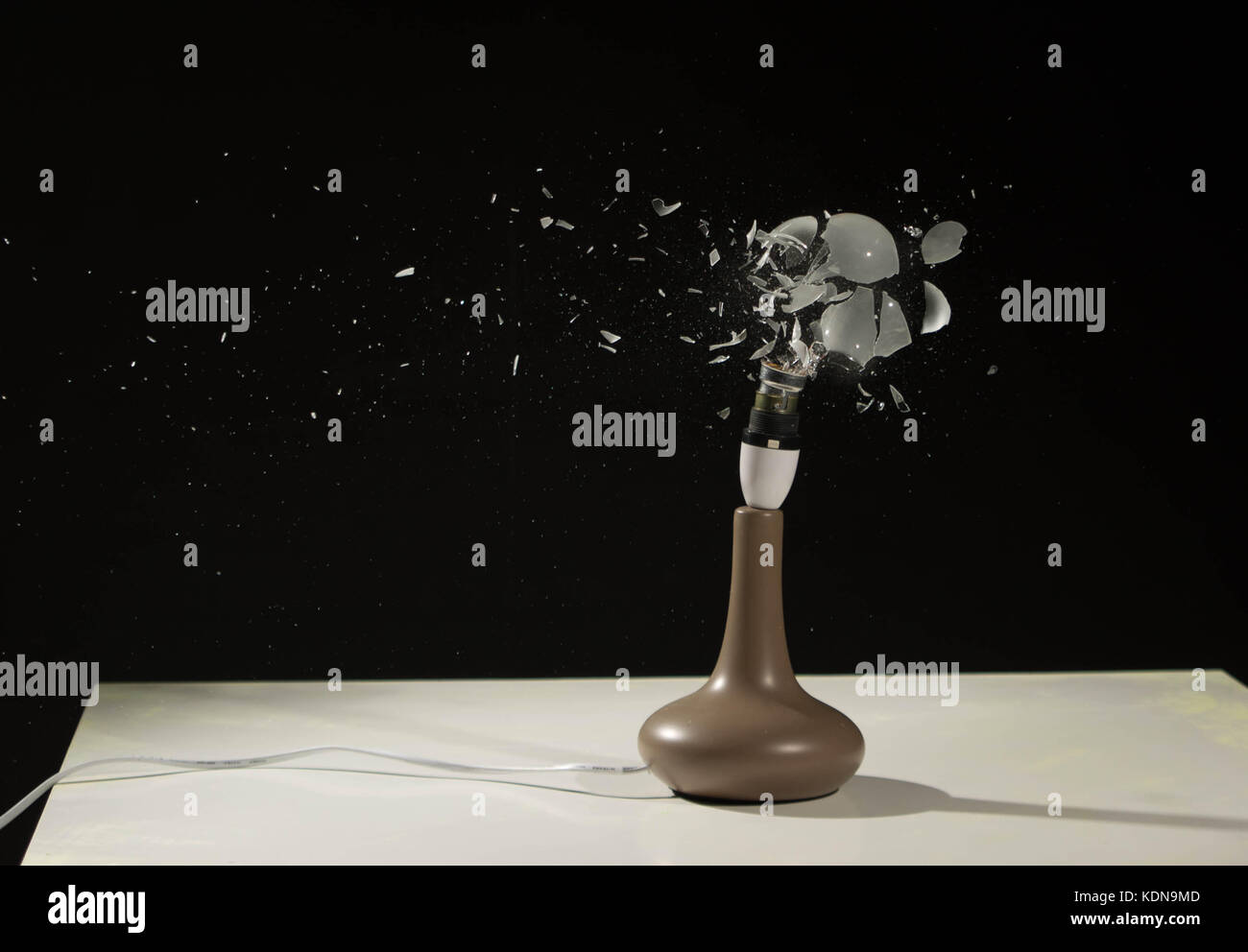 Pellet hitting Exploding lightbulb Stock Photo - Alamy