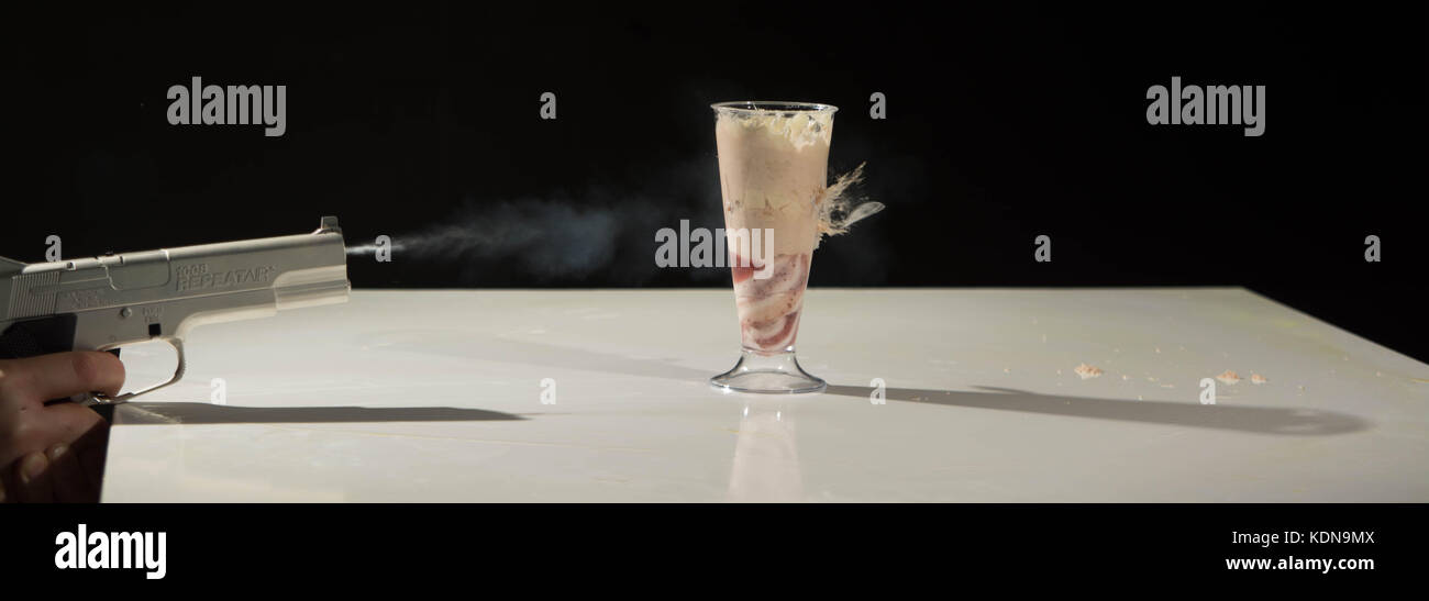 Pellet bursting through ice cream Stock Photo - Alamy