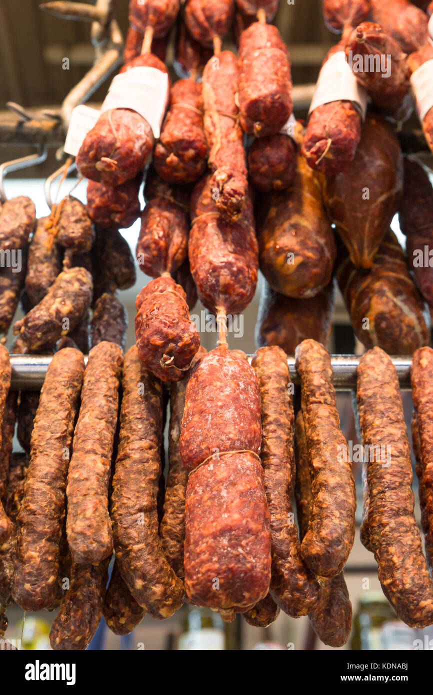 Salami, pepperoni and assorted cured dried meats hanging in Italian ...