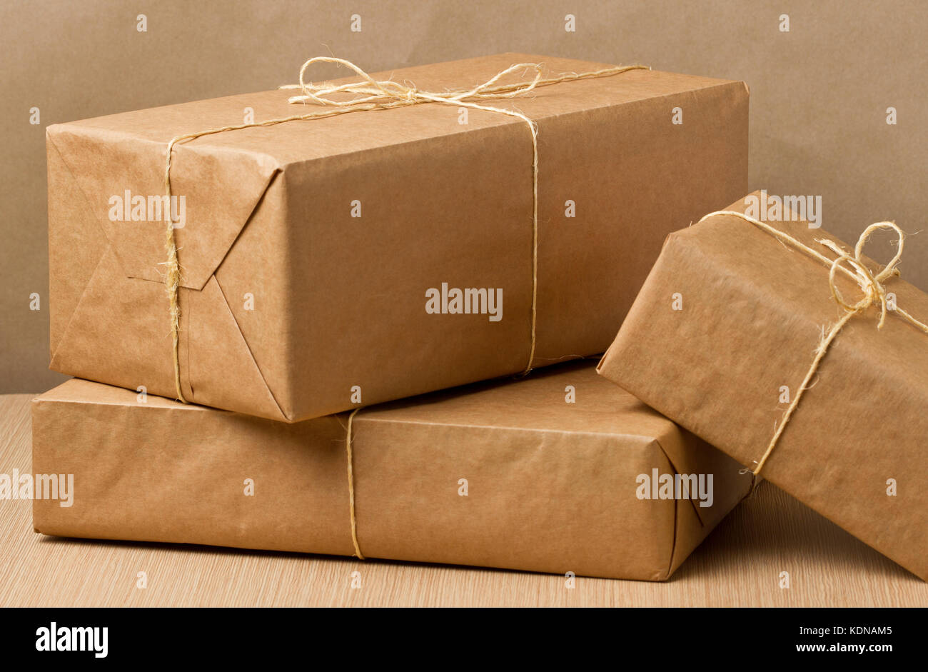 Parcel wrapped in brown paper and tied with rough twine Stock Photo - Alamy