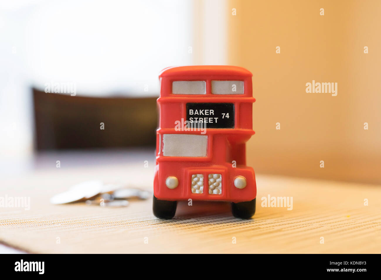 Red Bus Piggy Bank with Coins Stock Photo - Alamy