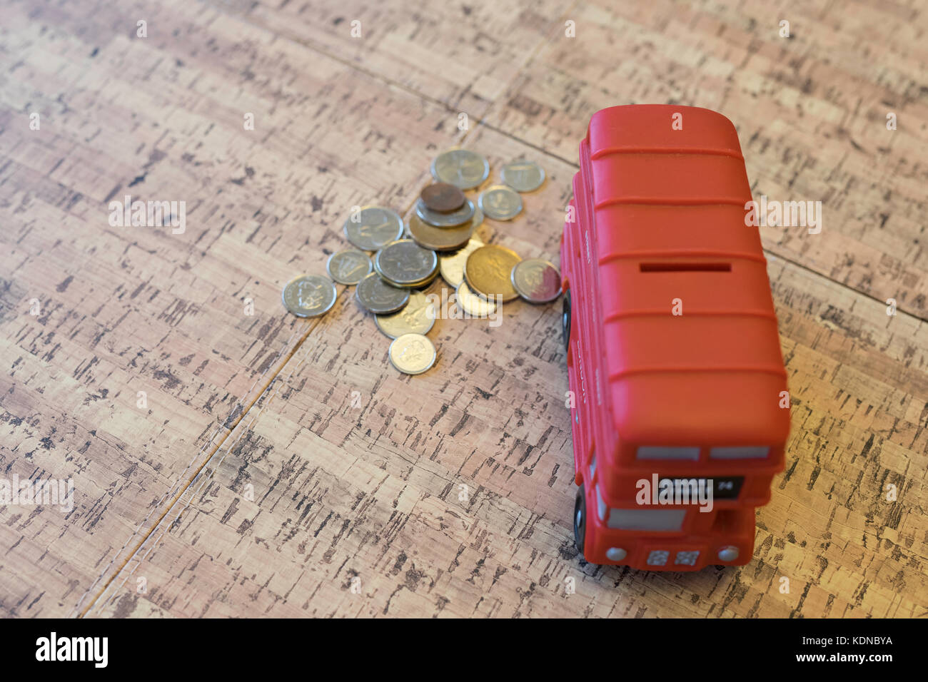 Red Bus Piggy Bank with Coins Stock Photo - Alamy