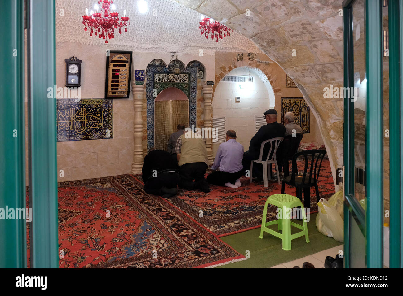 Muslim worshipers praying inside a small small mosque in Via Dolorosa ...