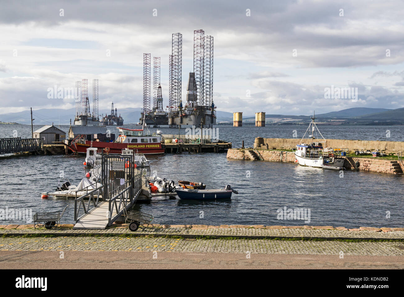 Cromarty harbour with Nigg ferry Renfrew Rose and moored oil platforms ...