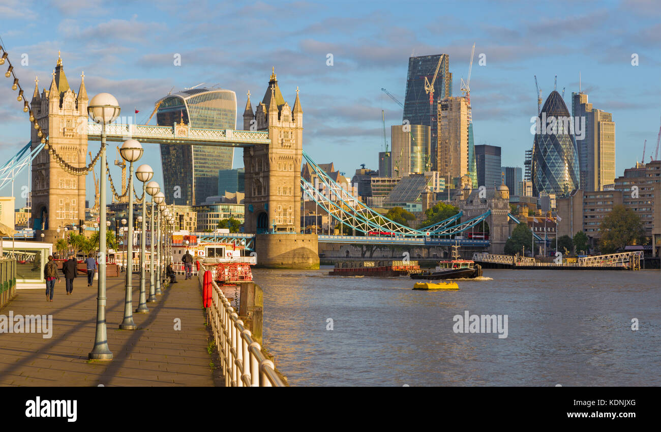 London - The Tower Bridge, promenade and skyscrapers in morning light ...