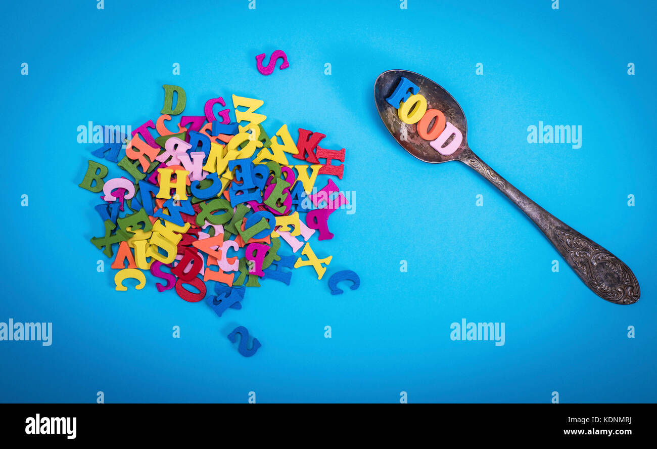 multicolored letters of the English alphabet and an iron spoon on a ...