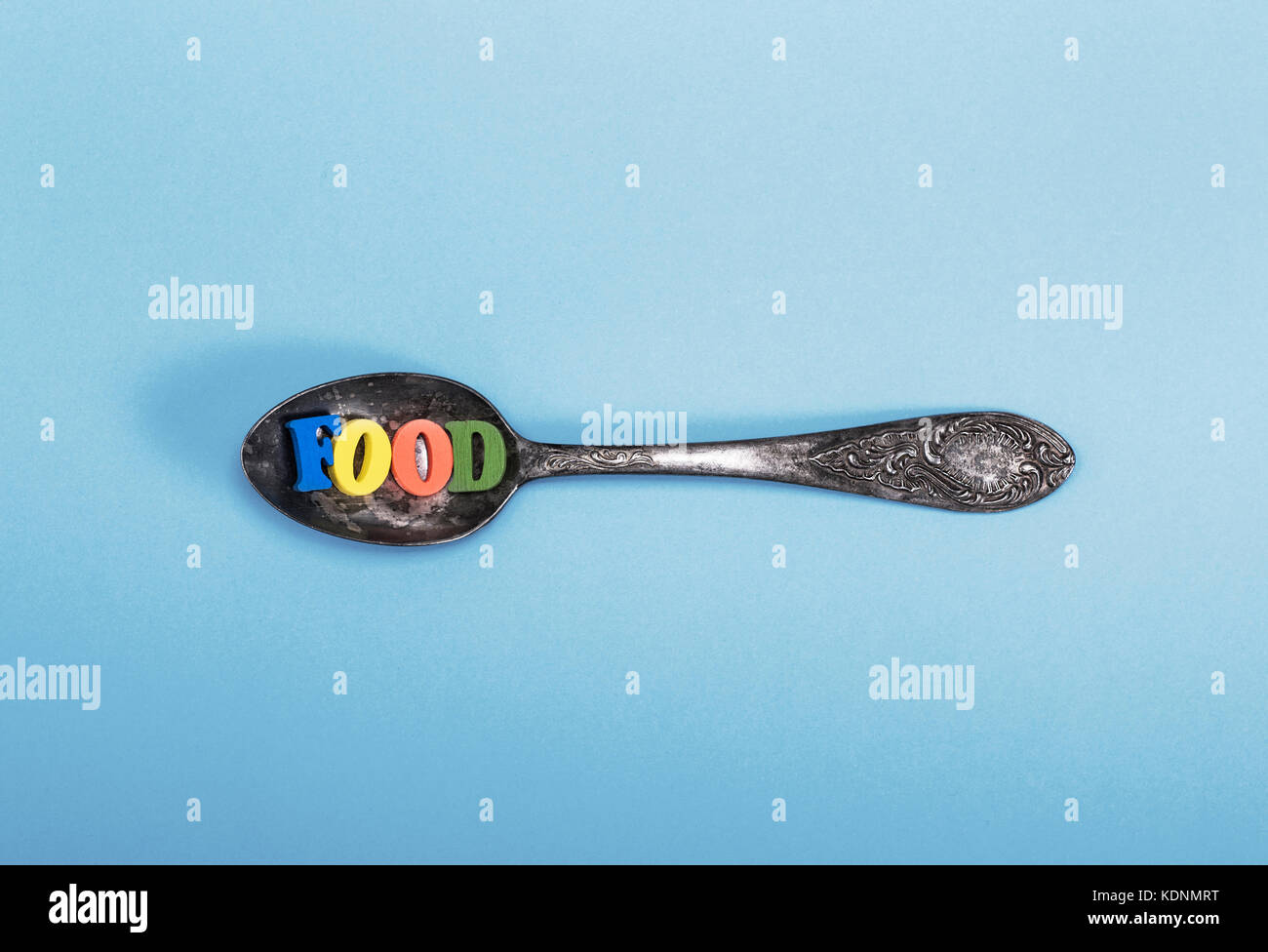 iron spoon and label food wooden letters, blue background Stock Photo ...