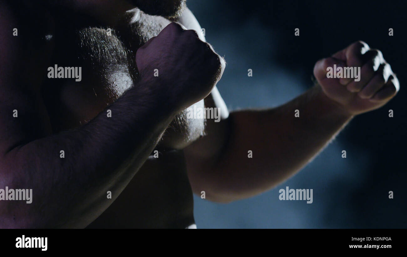 Boxing man ready to fight. Boxer with strong hands and clenched fists ...