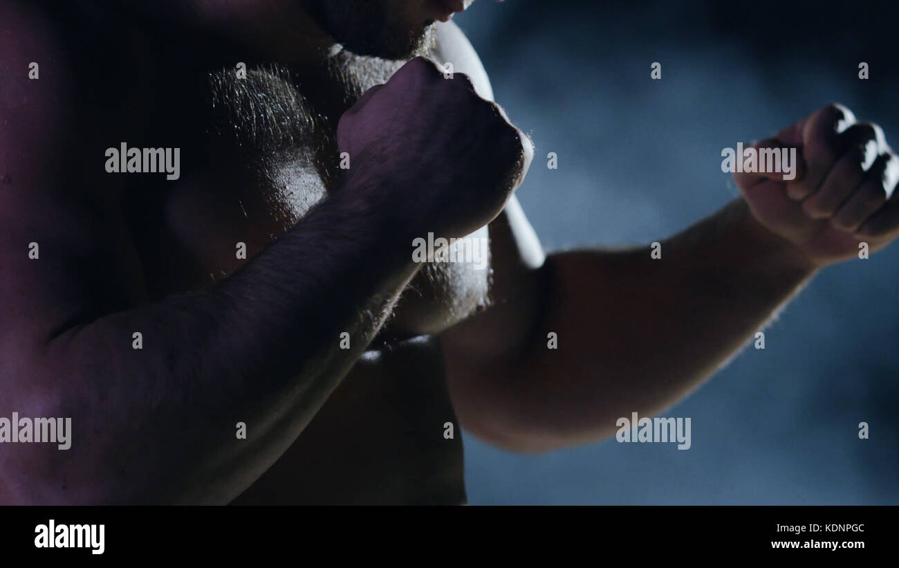 Boxing man ready to fight. Boxer with strong hands and clenched fists ...