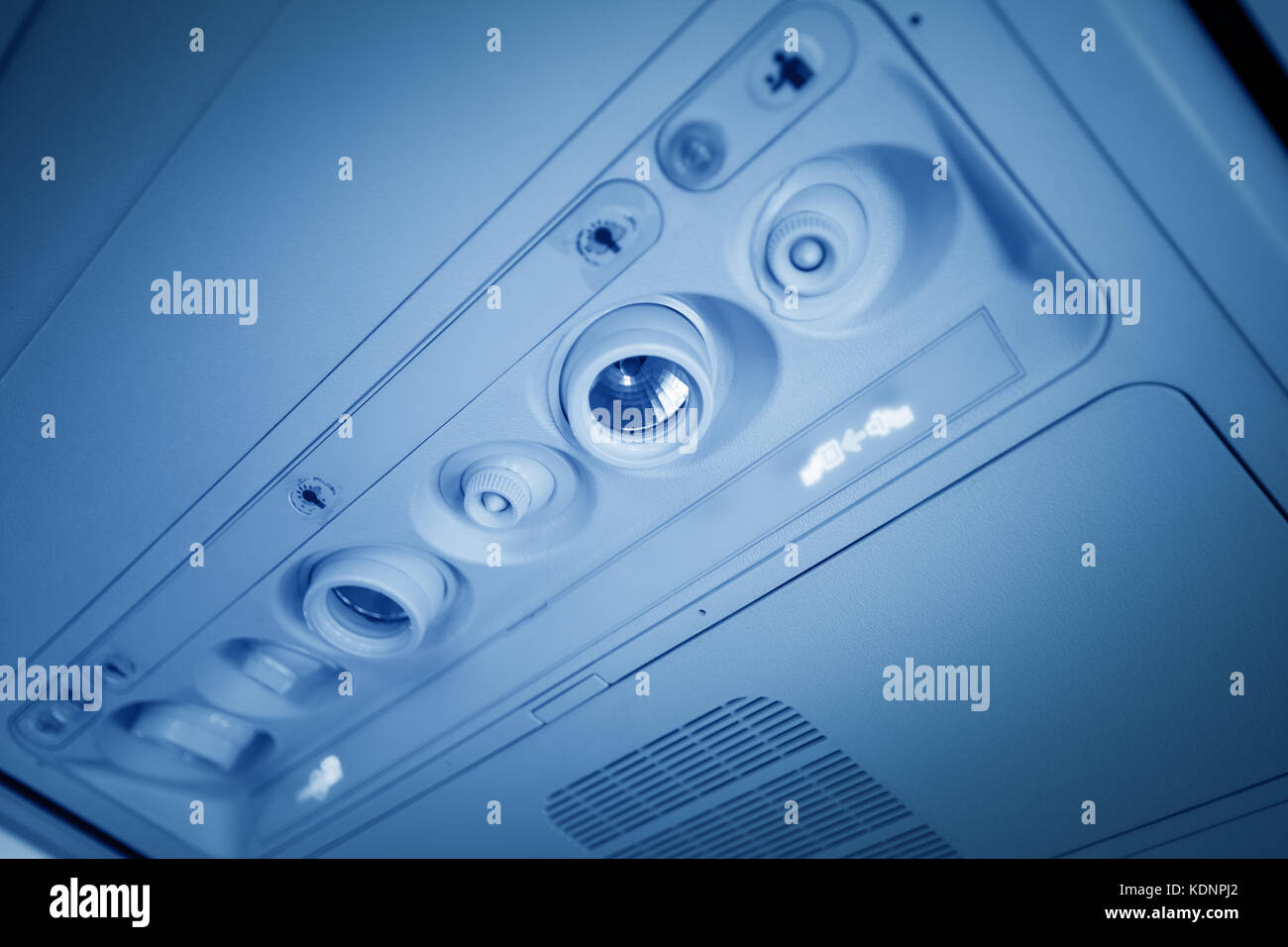 Cabin inside the aircraft, lights, air condition and signs panel above ...