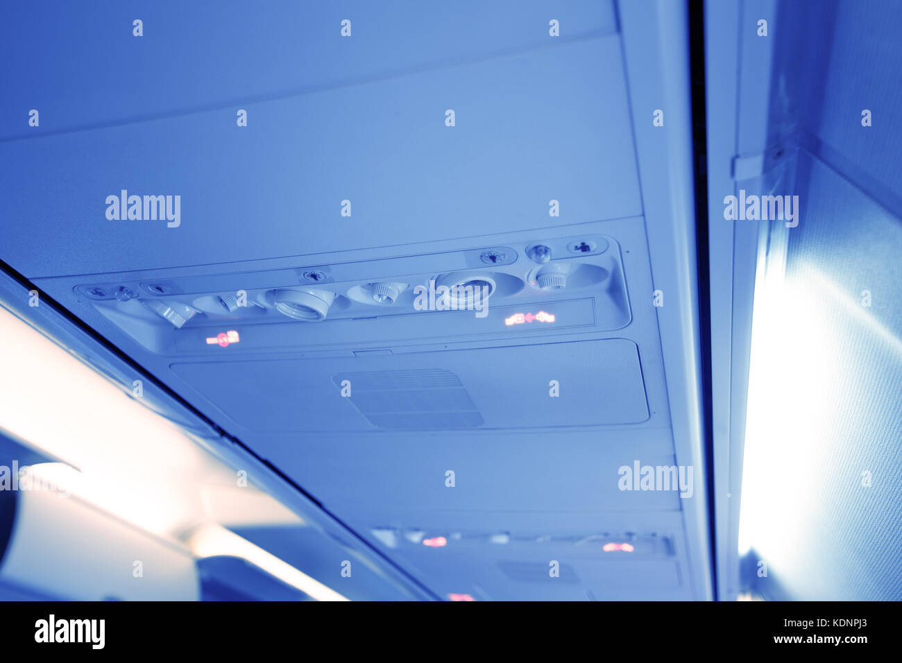 Cabin inside the aircraft, lights, air condition and signs panel above ...