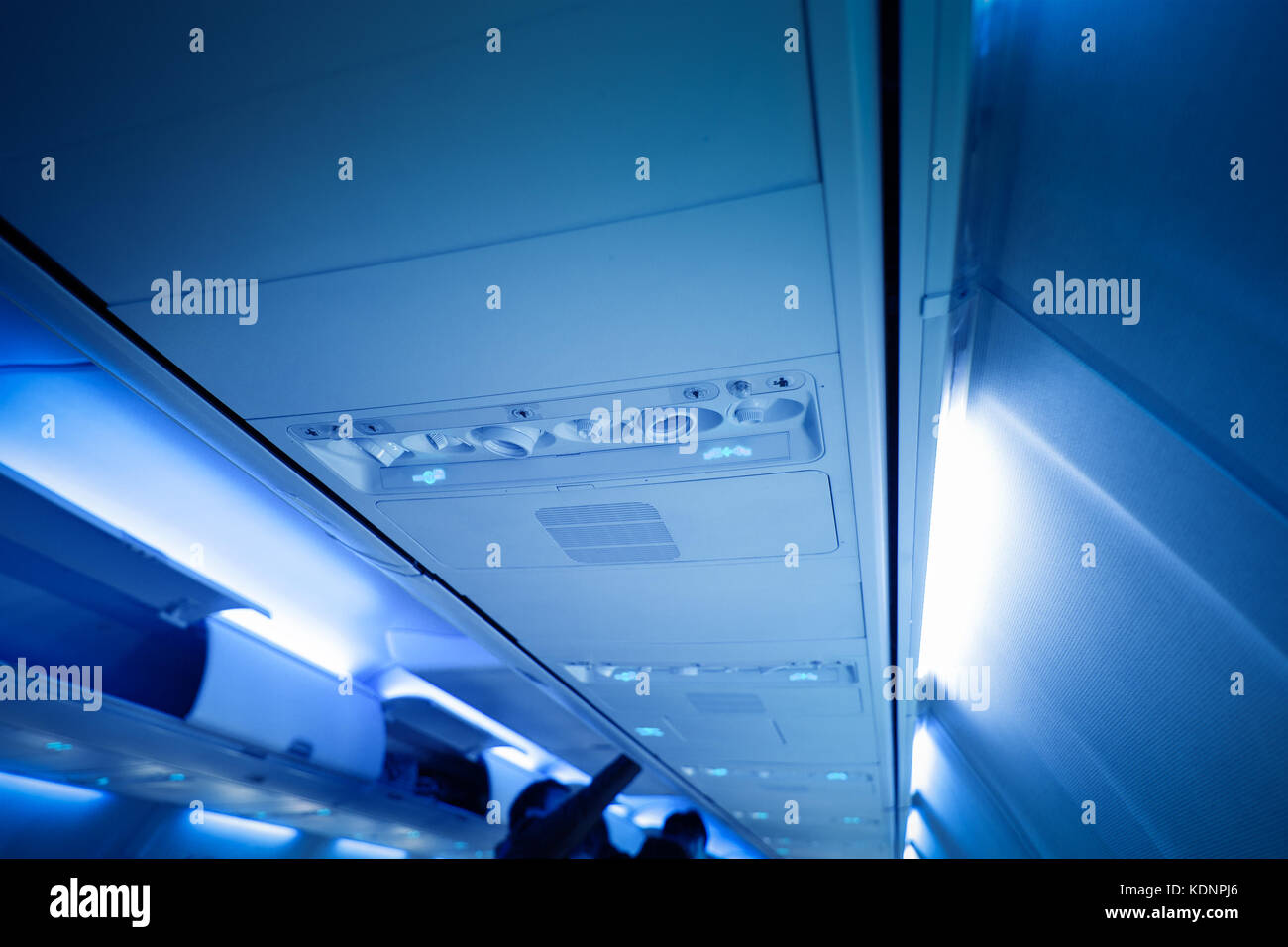 Cabin inside the aircraft, lights, air condition and signs panel above ...