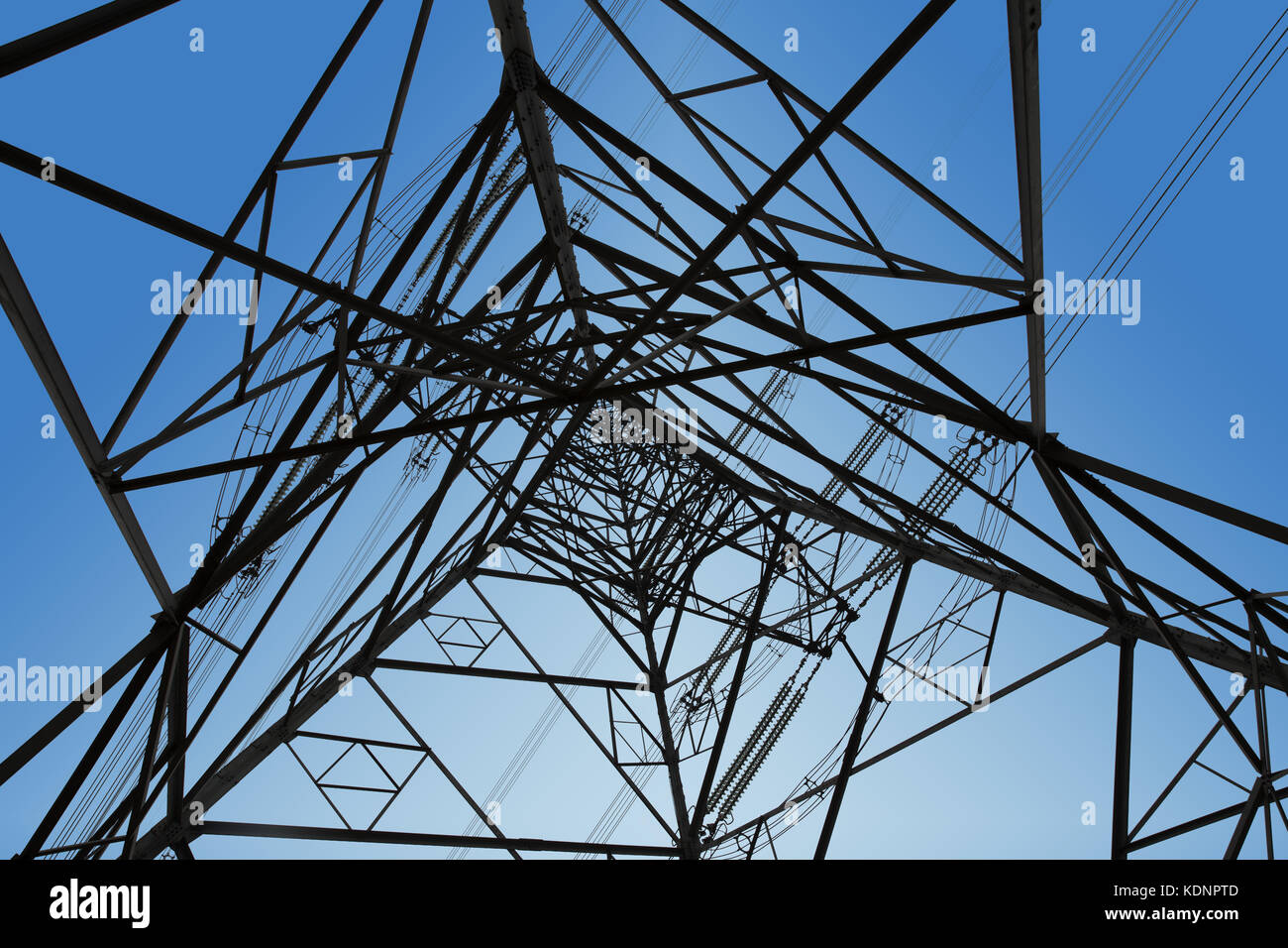 Detail of electricity pylon against blue sky: high voltage electric ...