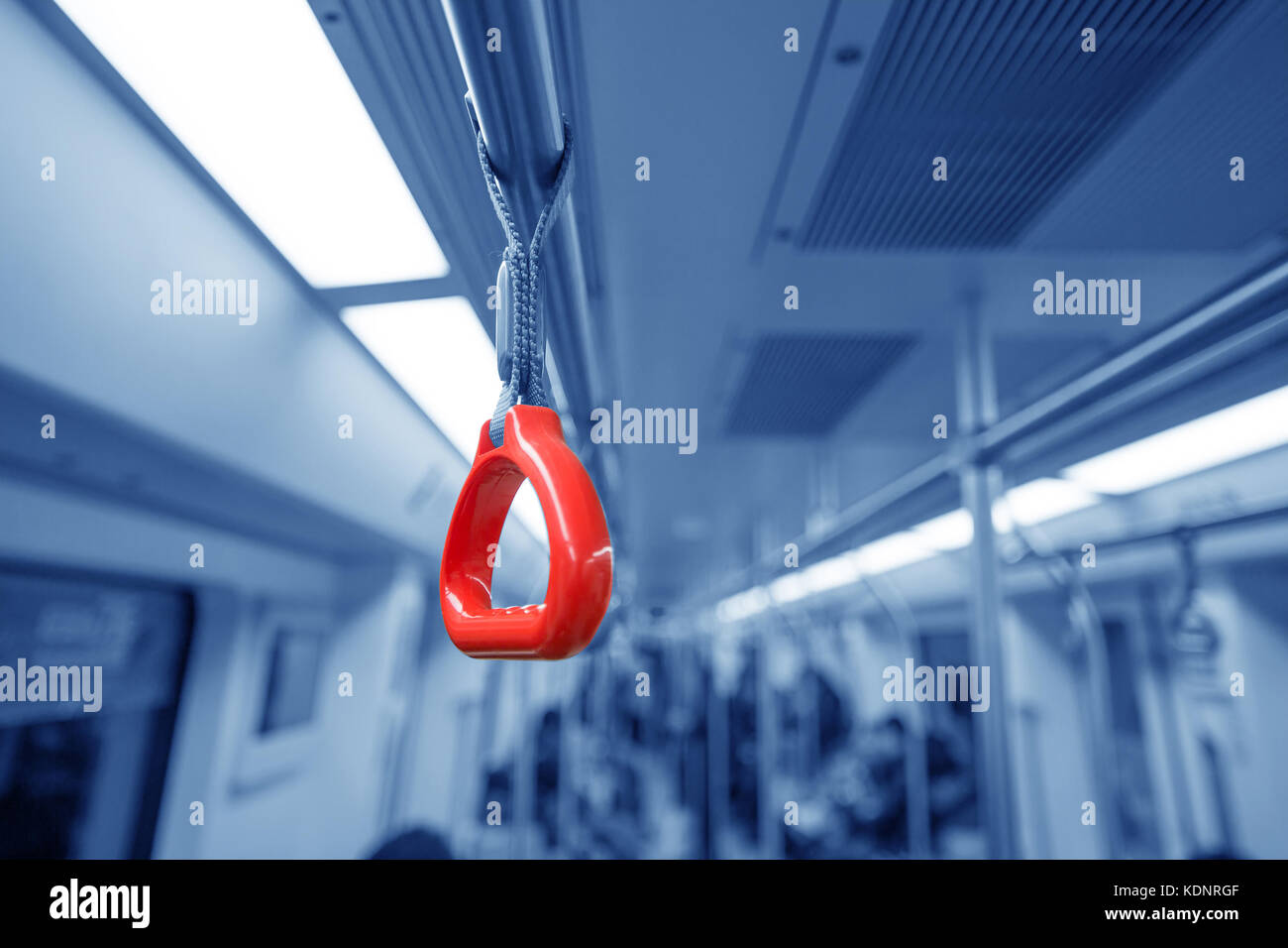 Handles for standing passenger in electric train Stock Photo - Alamy