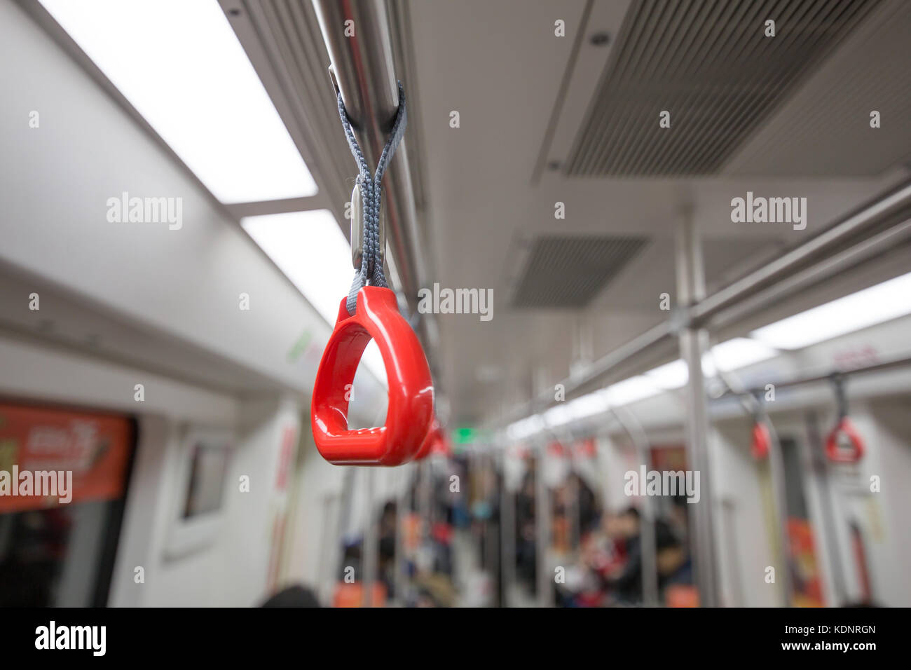 Handles for standing passenger in electric train Stock Photo - Alamy