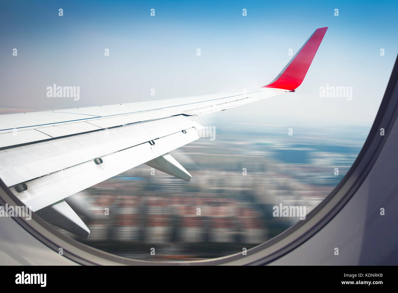 Airplane wing out of window Stock Photo - Alamy