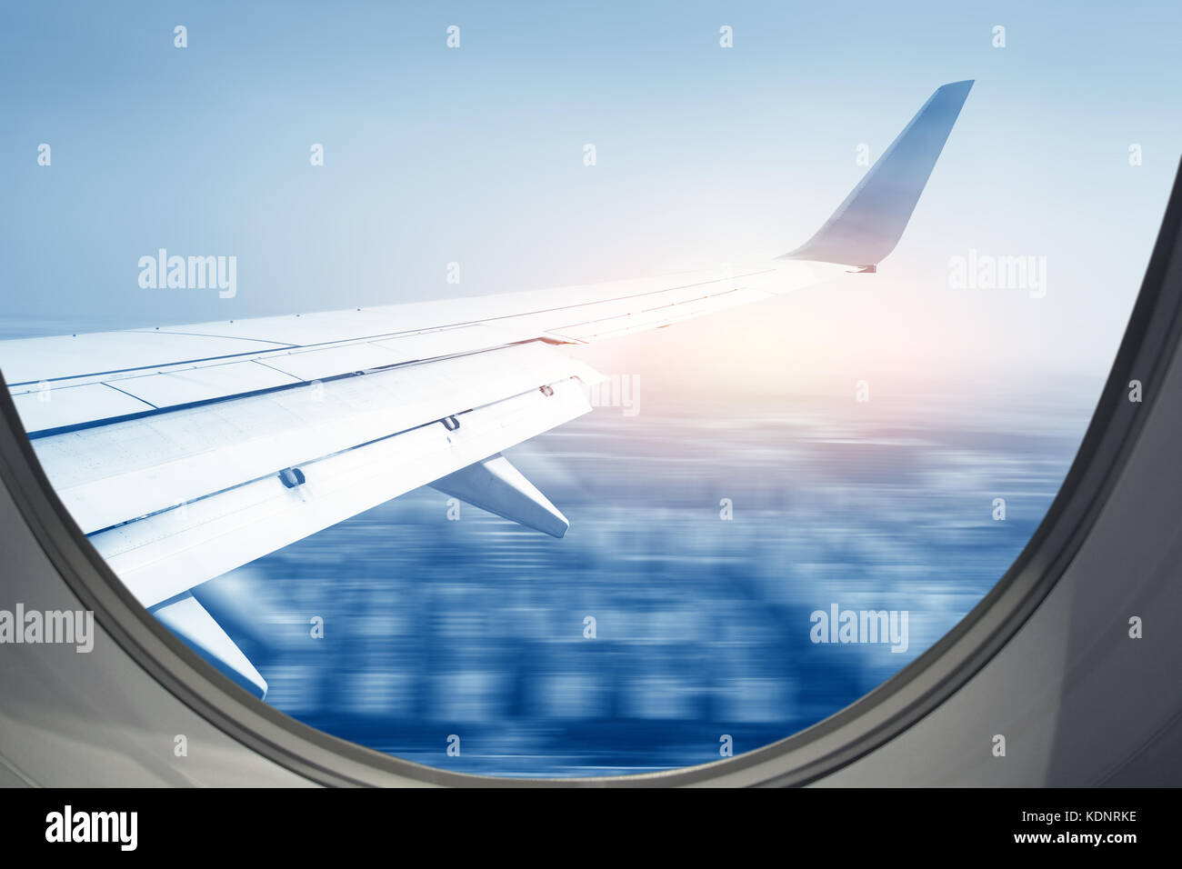 Airplane wing out of window Stock Photo - Alamy