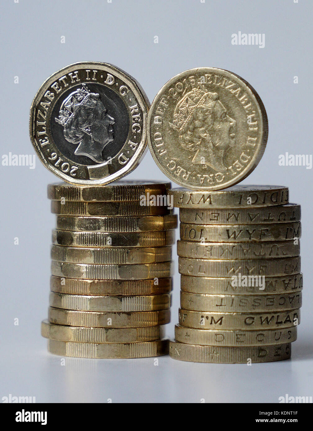 Examples of the old 1 pound coin (right) and the new one replacing it ...