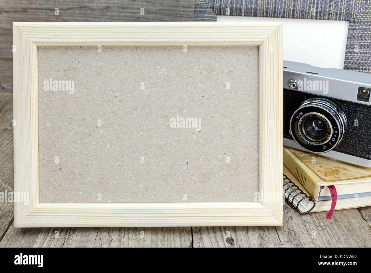 retro camera, photo frame and notebooks on grunge wooden background in ...