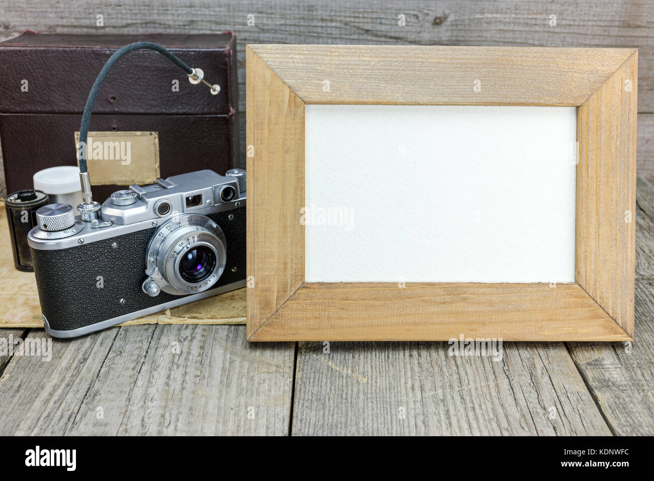old classic camera and photo frame on gray wooden grunge background ...