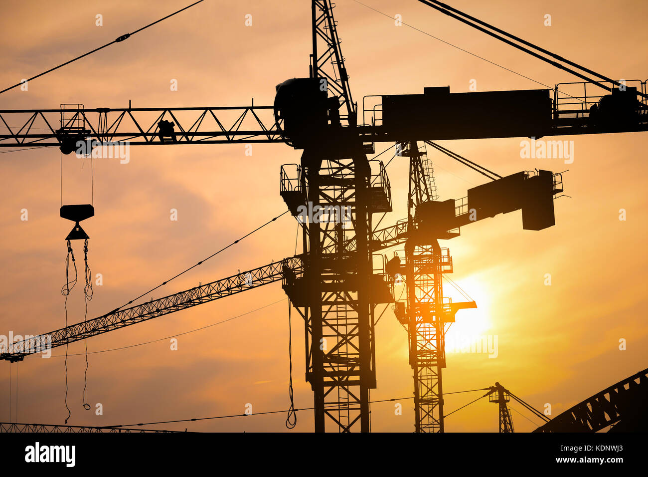 Abstract Industrial background with construction cranes silhouettes ...