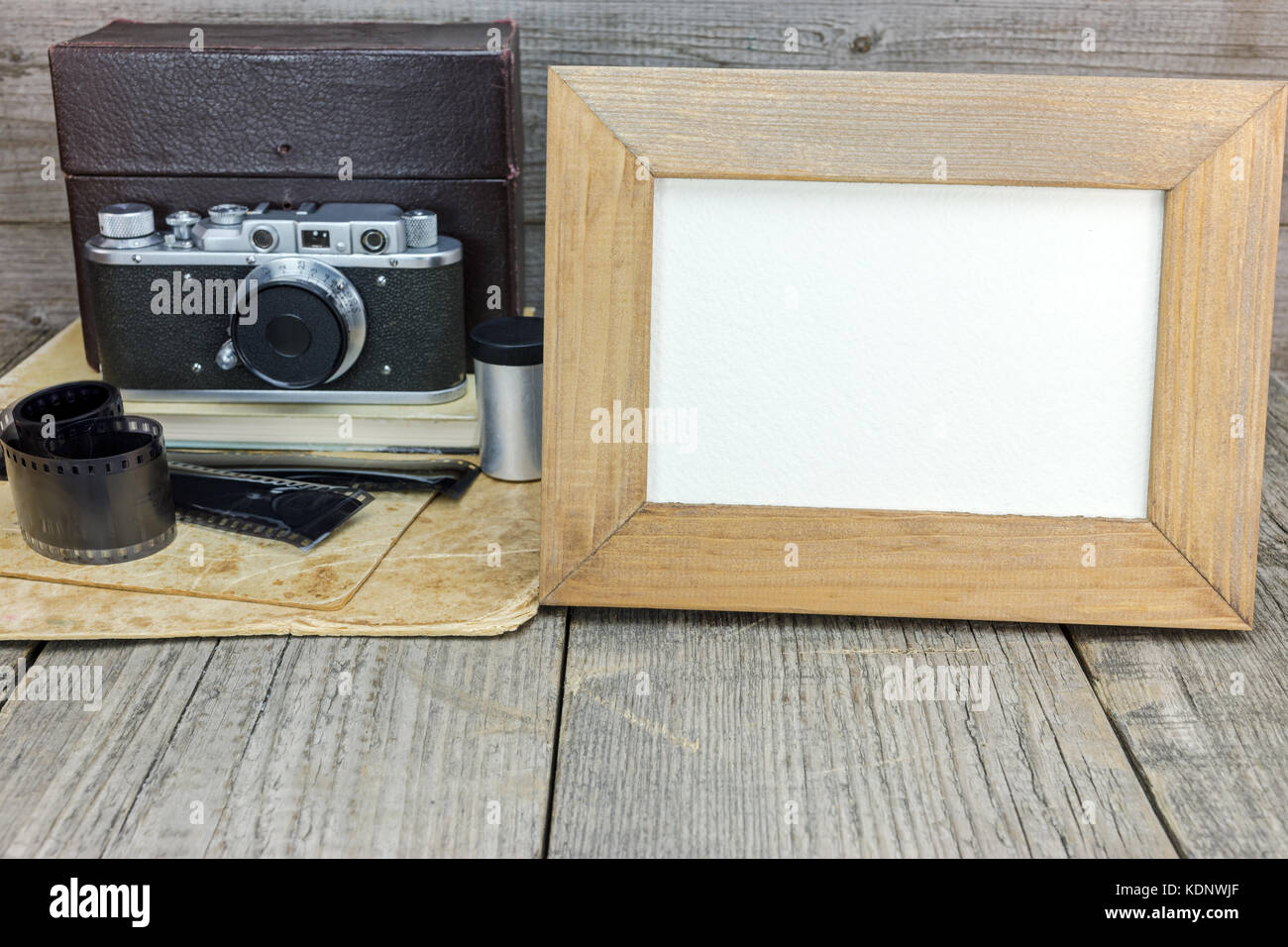 vintage camera, negative films, old photos and empty frame on grunge ...