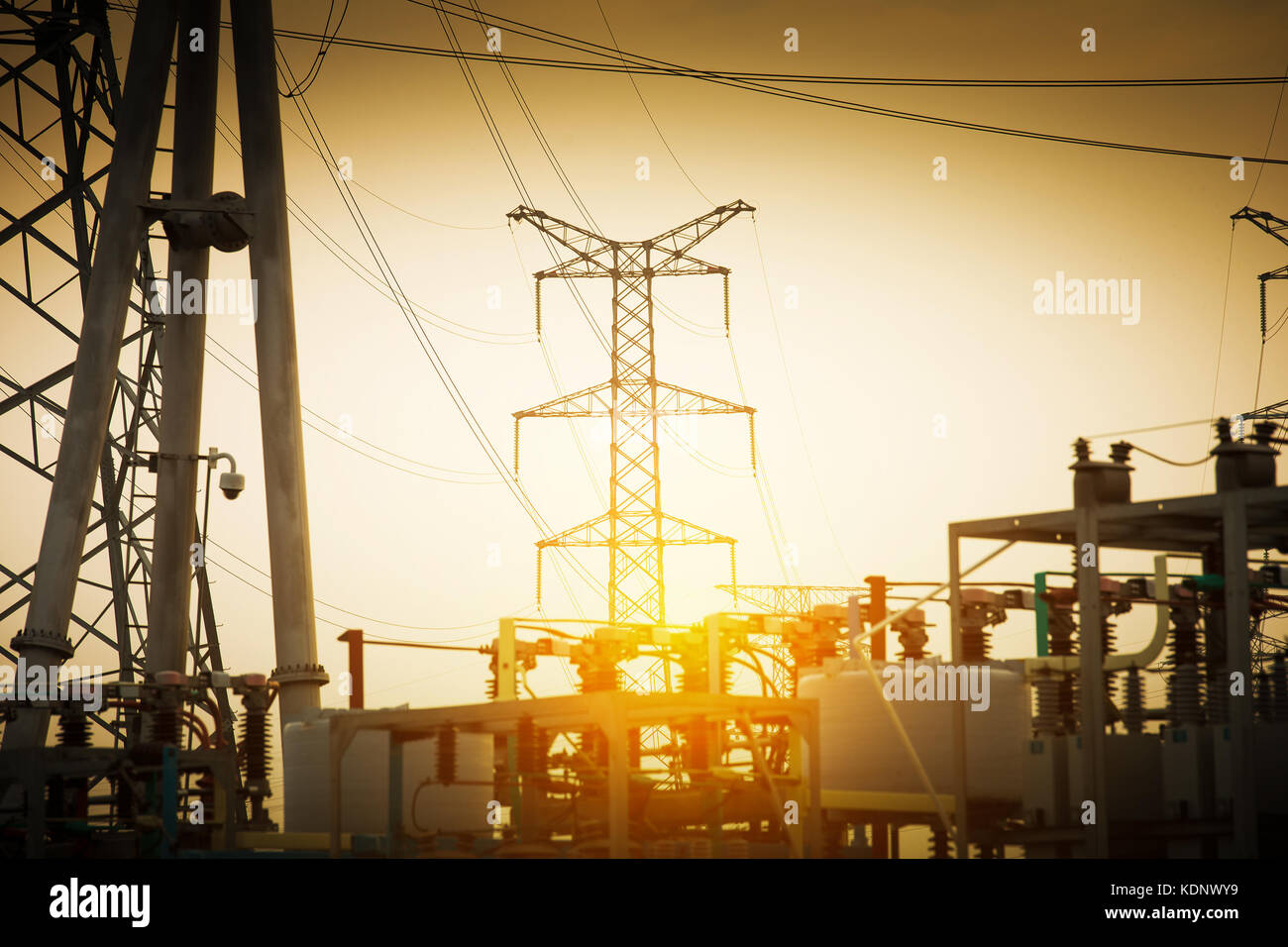 Silhouette of transformers over yellow sunset sky Stock Photo - Alamy
