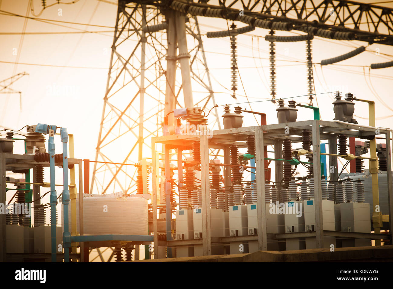 Silhouette of transformers over yellow sunset sky Stock Photo - Alamy