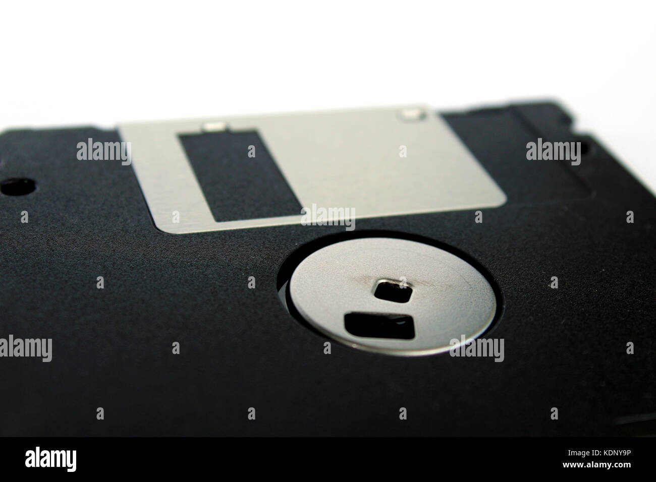Detail of a black floppy disk isolated on white background (back side ...