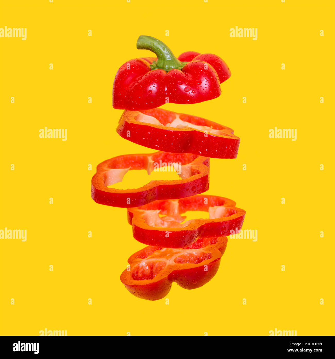 Creative concept with Flying red capsicum. Sliced floating bell pepper ...