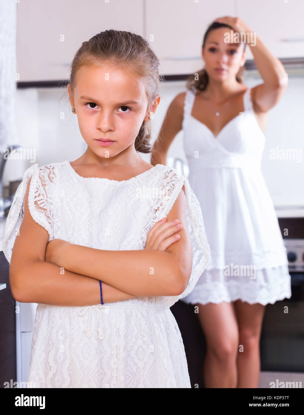 Upset little girl and angry mother arguing indoors Stock Photo - Alamy