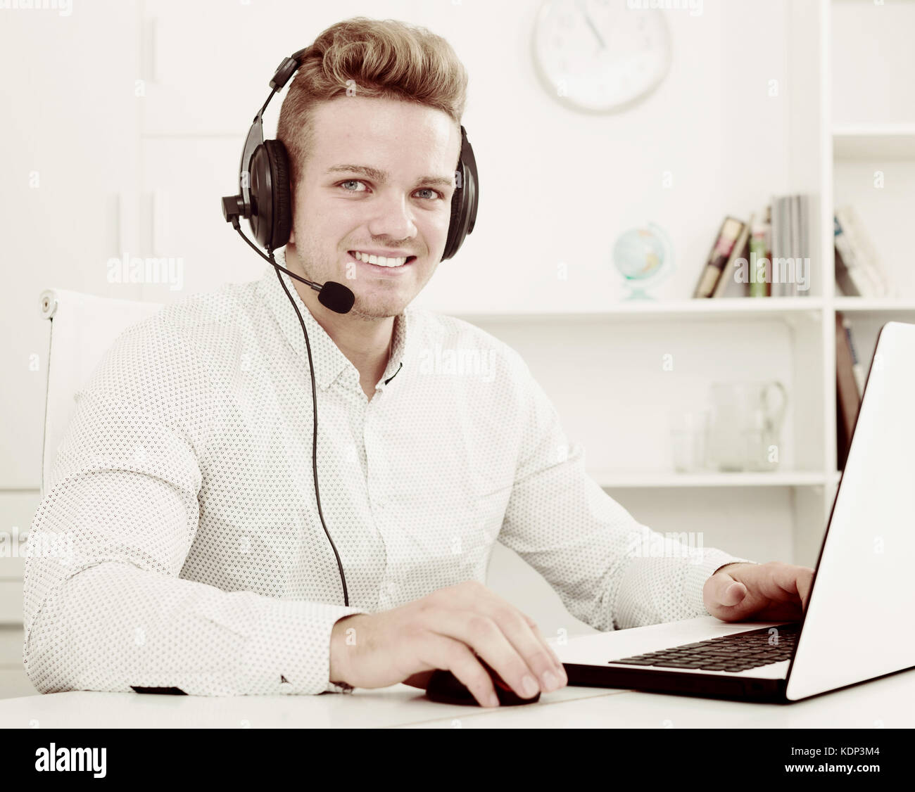 Positive call center male operator talking with client in agency Stock ...