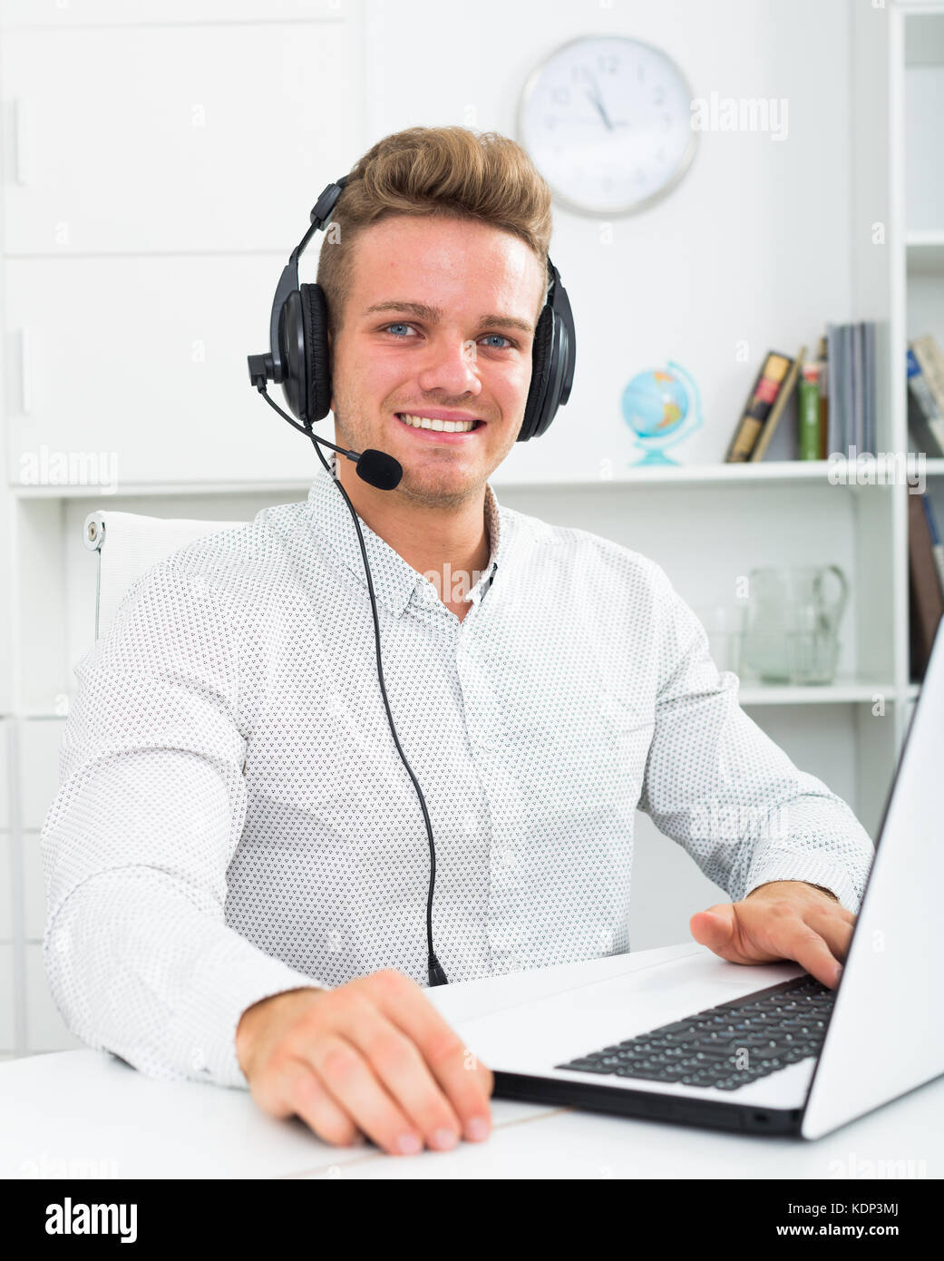 Positive call center male operator talking with client in agency Stock ...