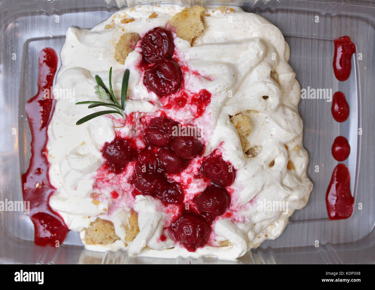 Melted sour cherries cake dessert in plastic container on hot day Stock ...