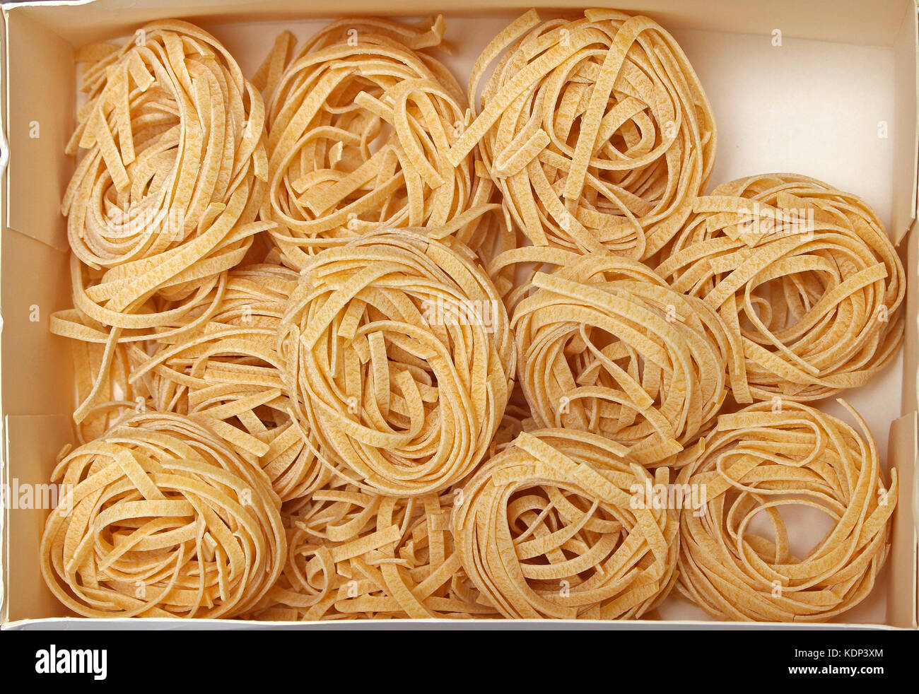 Dry Italian pasta tagliatelle nests in box Stock Photo - Alamy