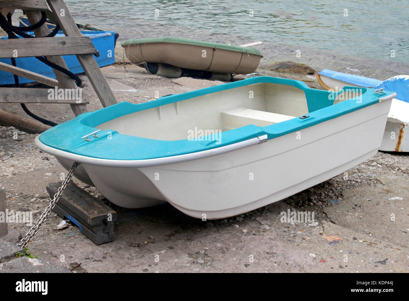 Small rowing boat docked on shore sand Stock Photo - Alamy