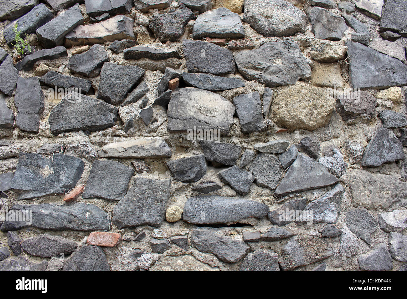 Detailed texture of stone wall with cracks between Stock Photo - Alamy