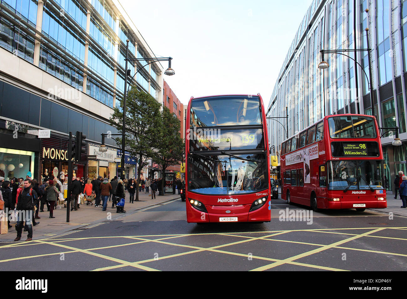 Famous red buses on Oxford street traffic and pedestrians walking in ...