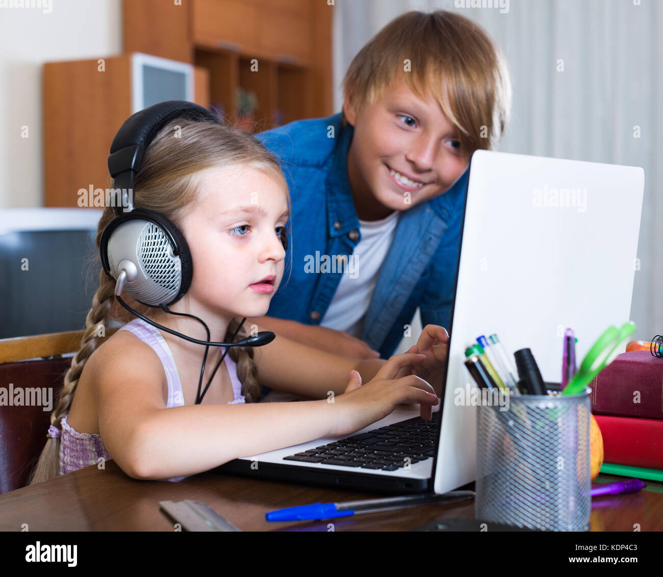 Children playing game online on laptop at home Stock Photo - Alamy