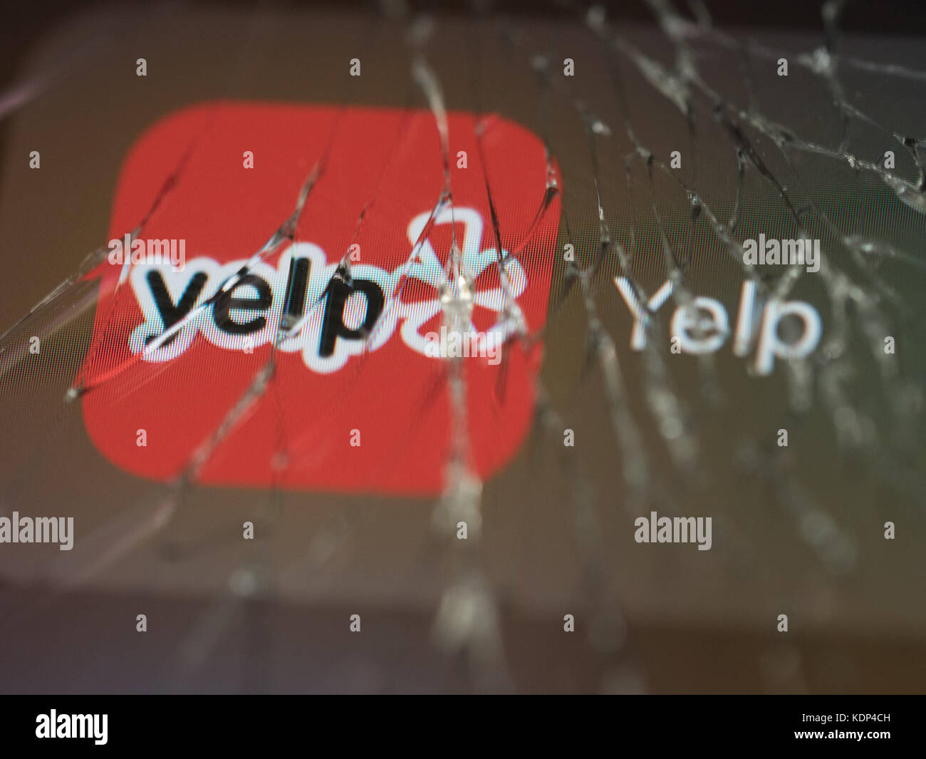The Yelp logo on a shattered smartphone screen Stock Photo - Alamy
