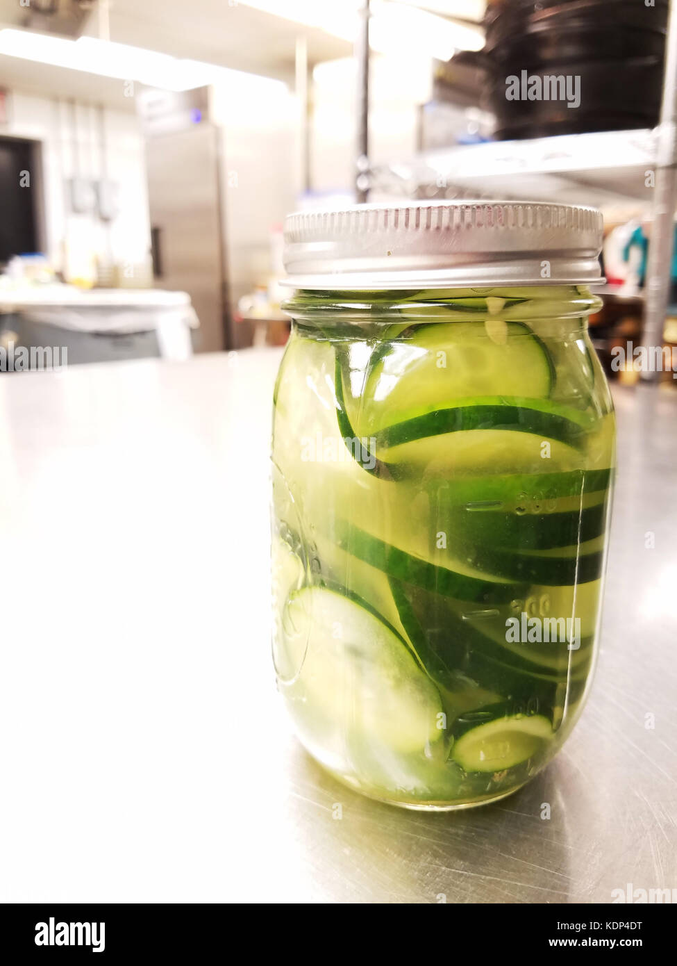 A jar of fresh pickles on a counter in a commercial kitchen Stock Photo ...