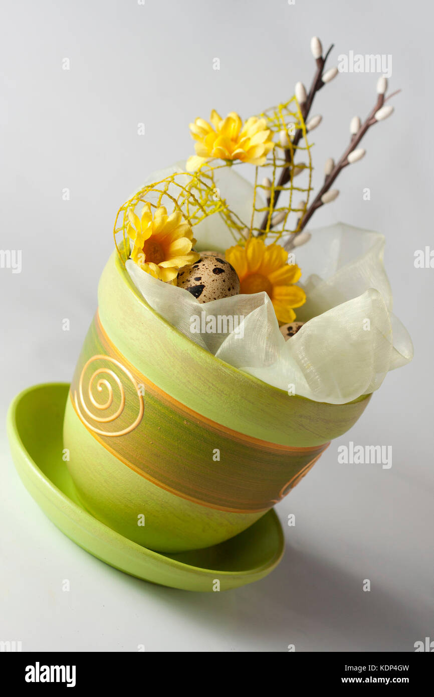 Green easter pot with flowers Stock Photo - Alamy