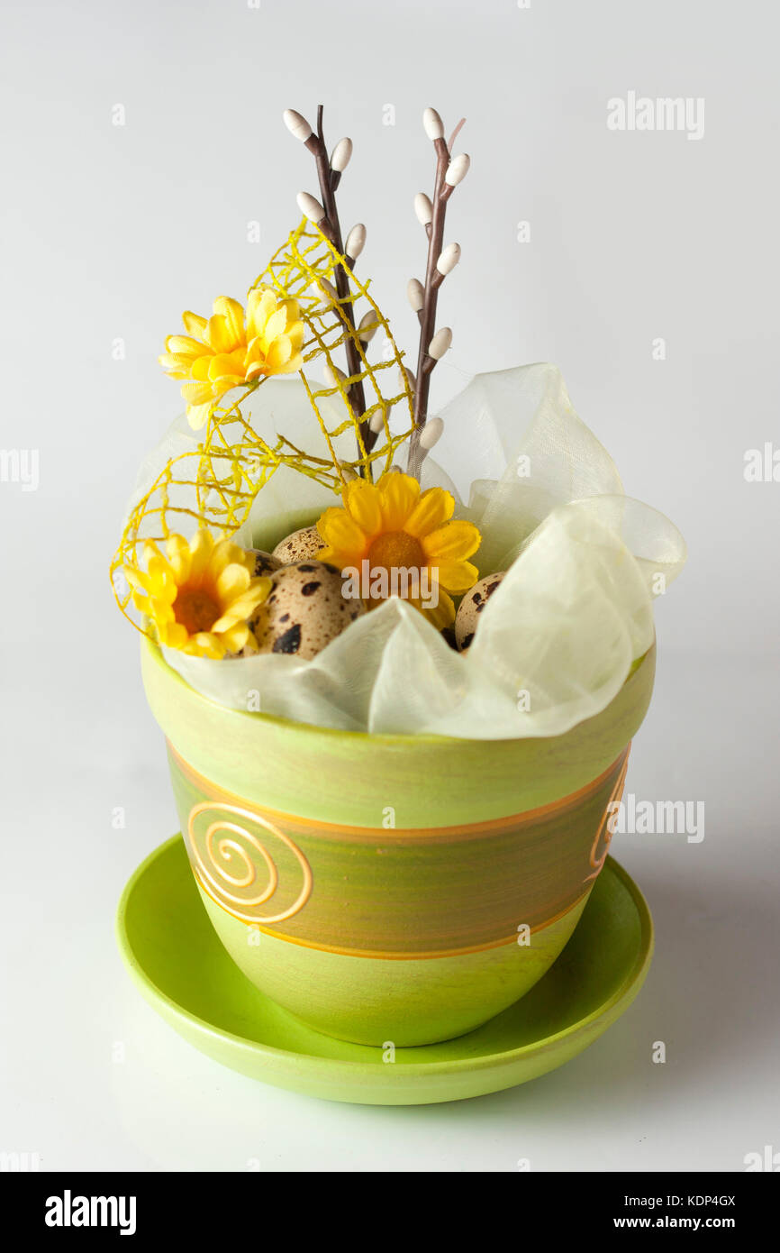 Green easter pot with flowers Stock Photo - Alamy
