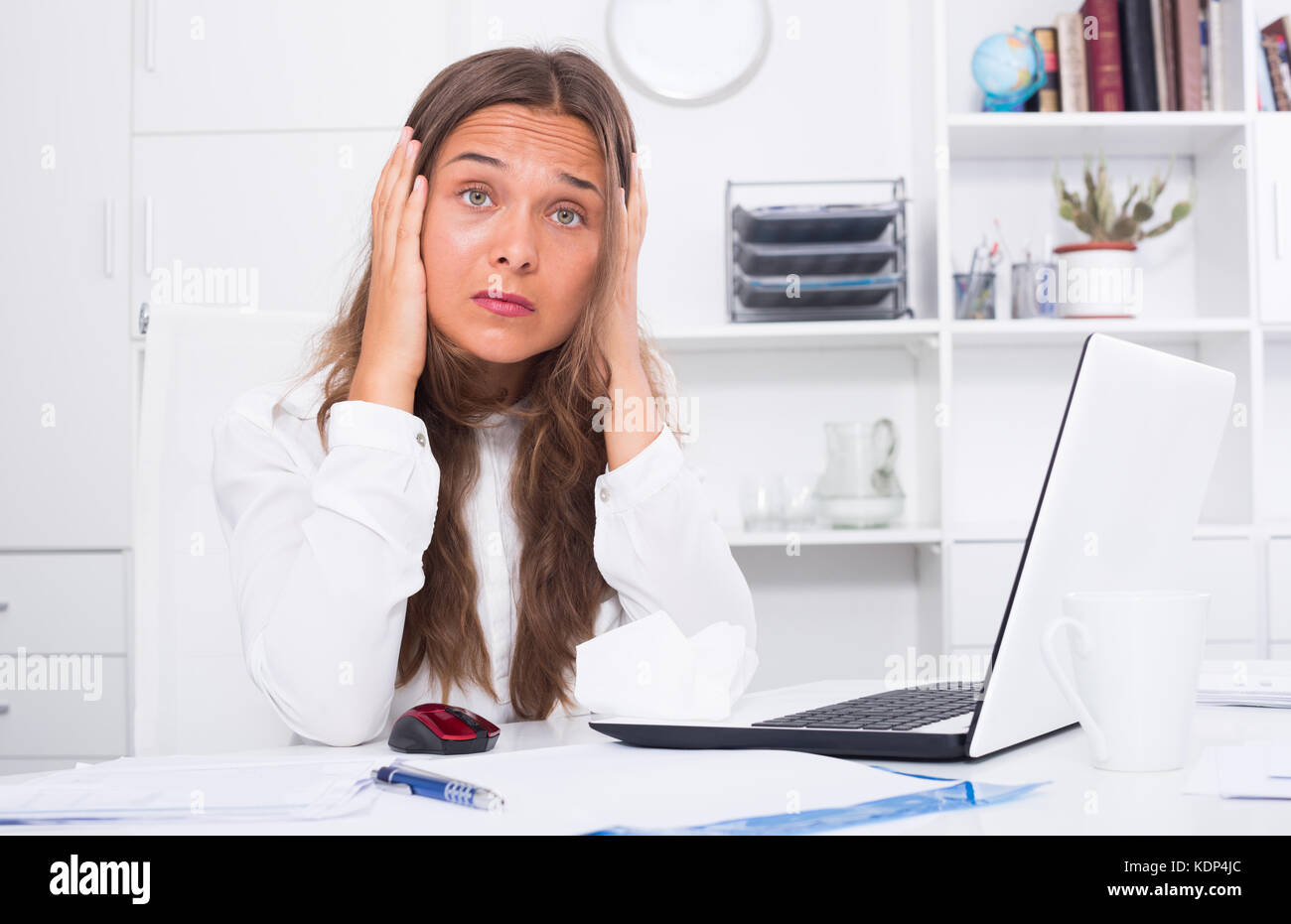 Portrait of sad young woman experiencing troubles at work office Stock ...
