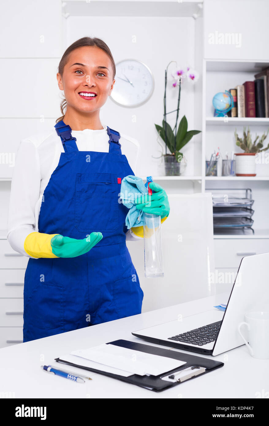 cheerful young female cleaner with duster at office Stock Photo - Alamy