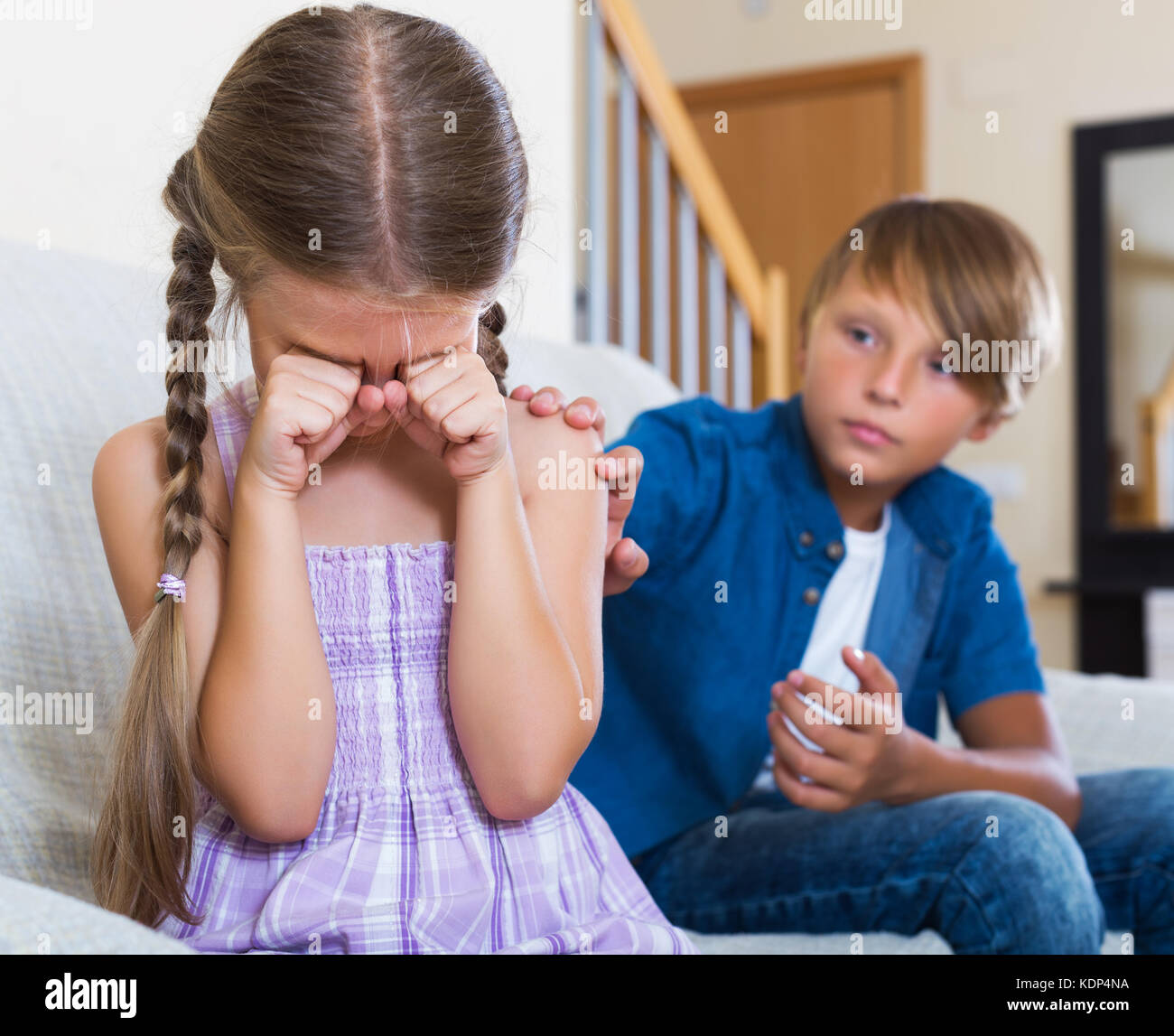 Frustrated children having serious fight in livingroom at home Stock ...