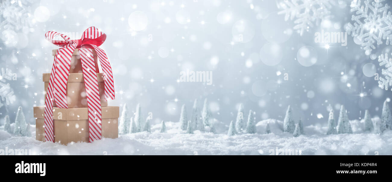 Stack of gift box on snow Stock Photo - Alamy