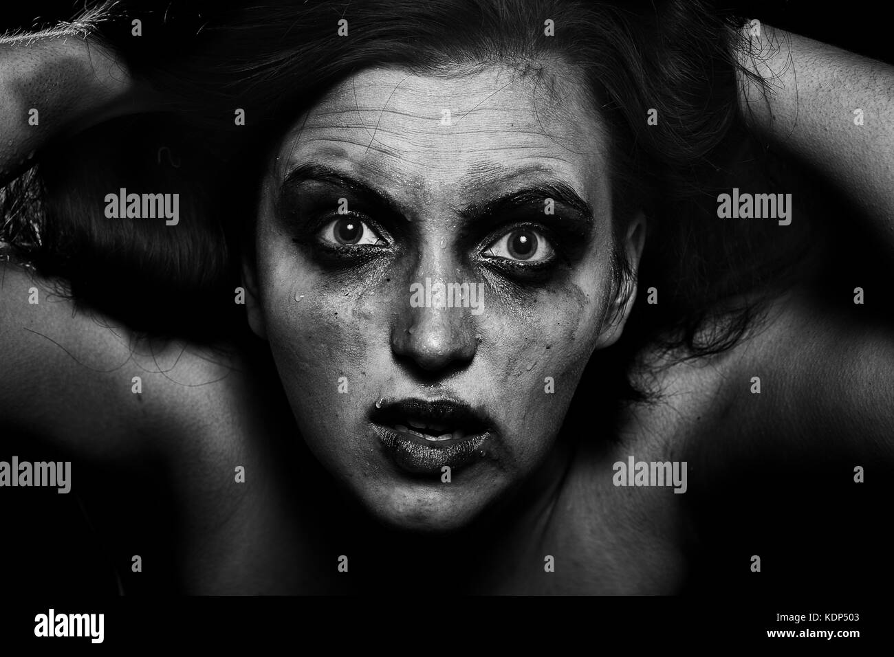sad woman with smeared cosmetics on dark background, monochrome Stock ...