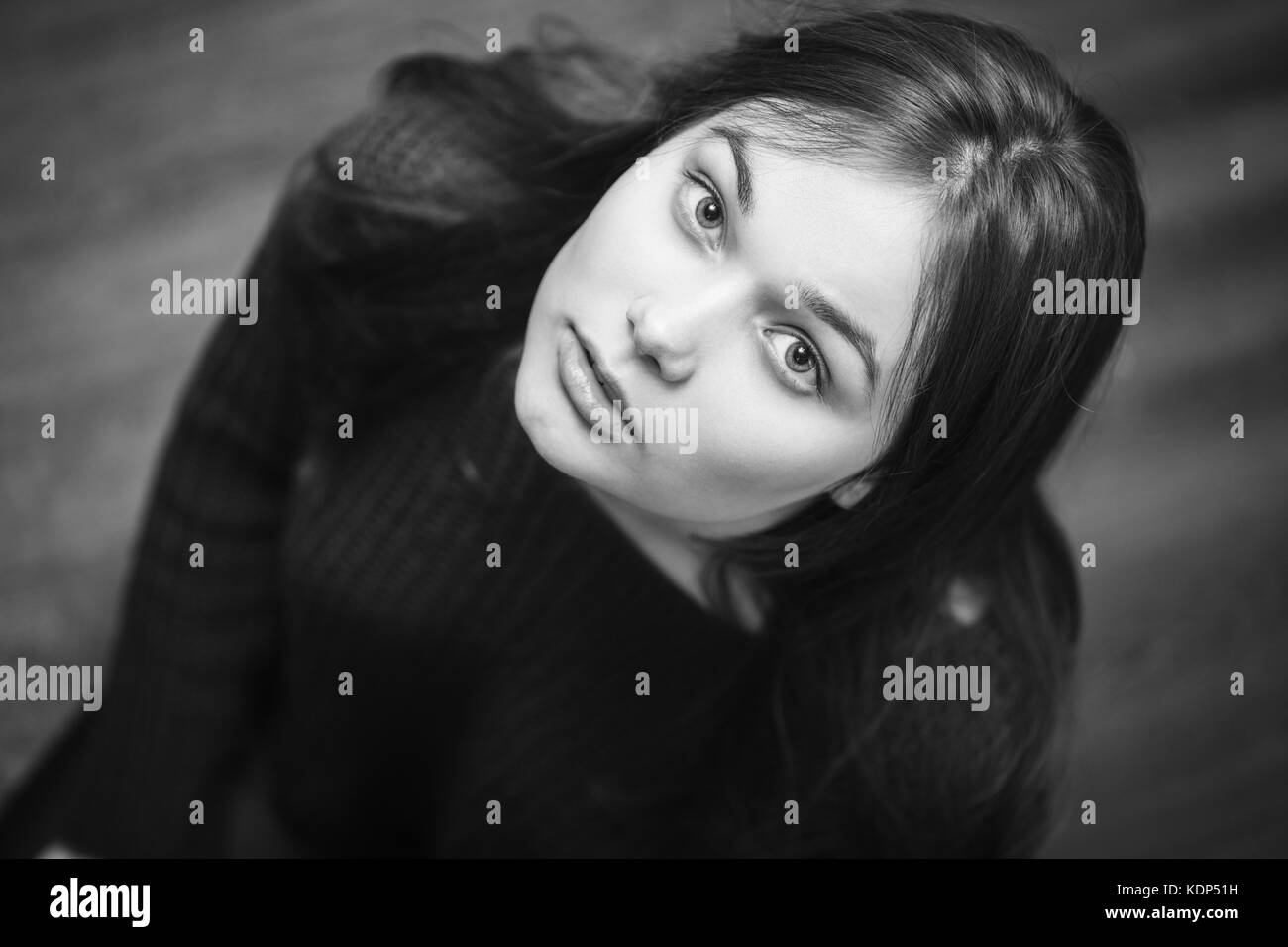 sad beautiful young woman looking up at camera, monochrome Stock Photo ...