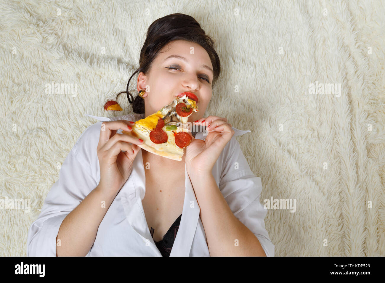 beautiful overeat businesswoman lying with pizza pieces eating Stock ...